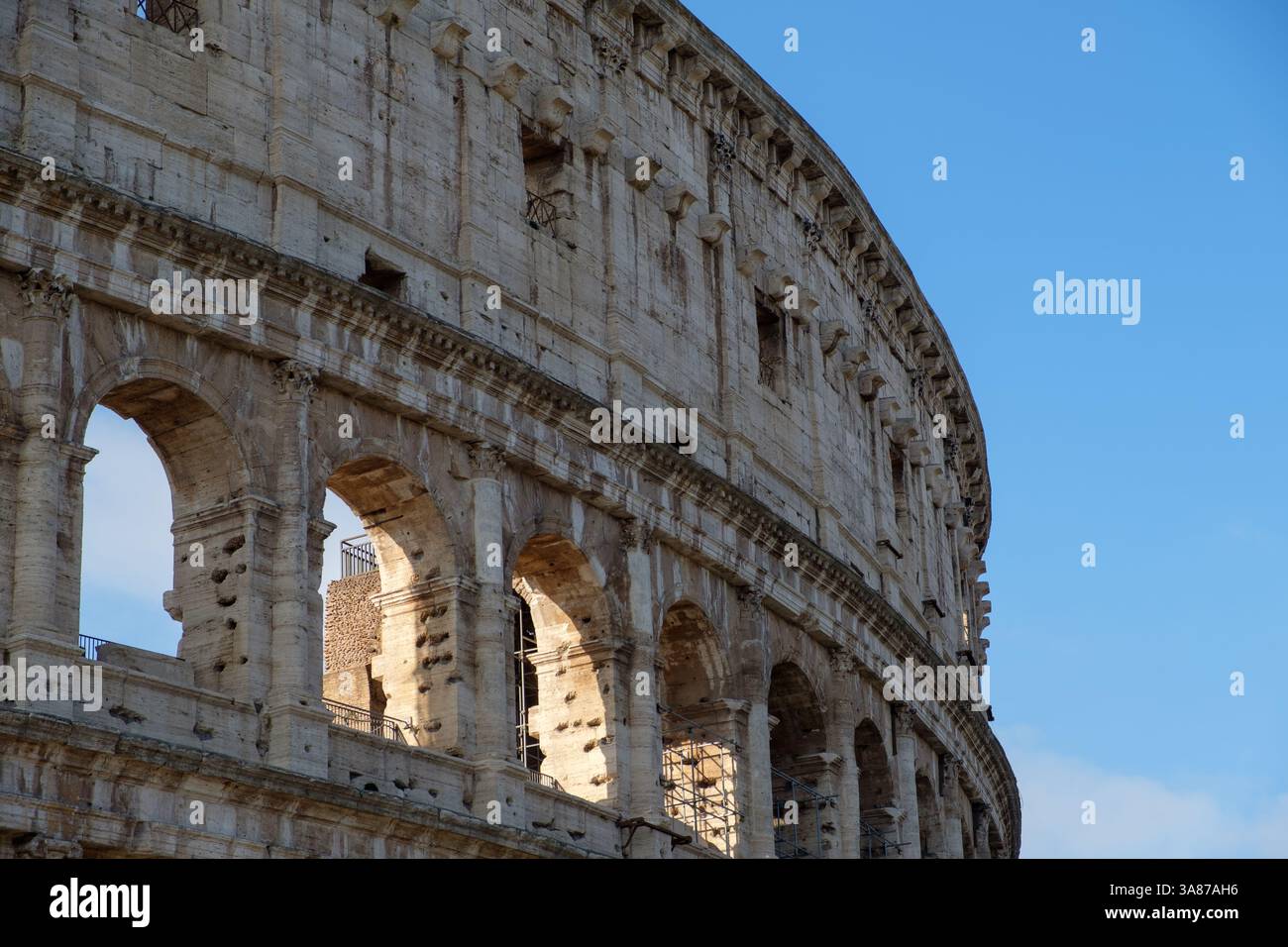 The exterior wall of the Colosseum in Rome, Italy, stands against a ...