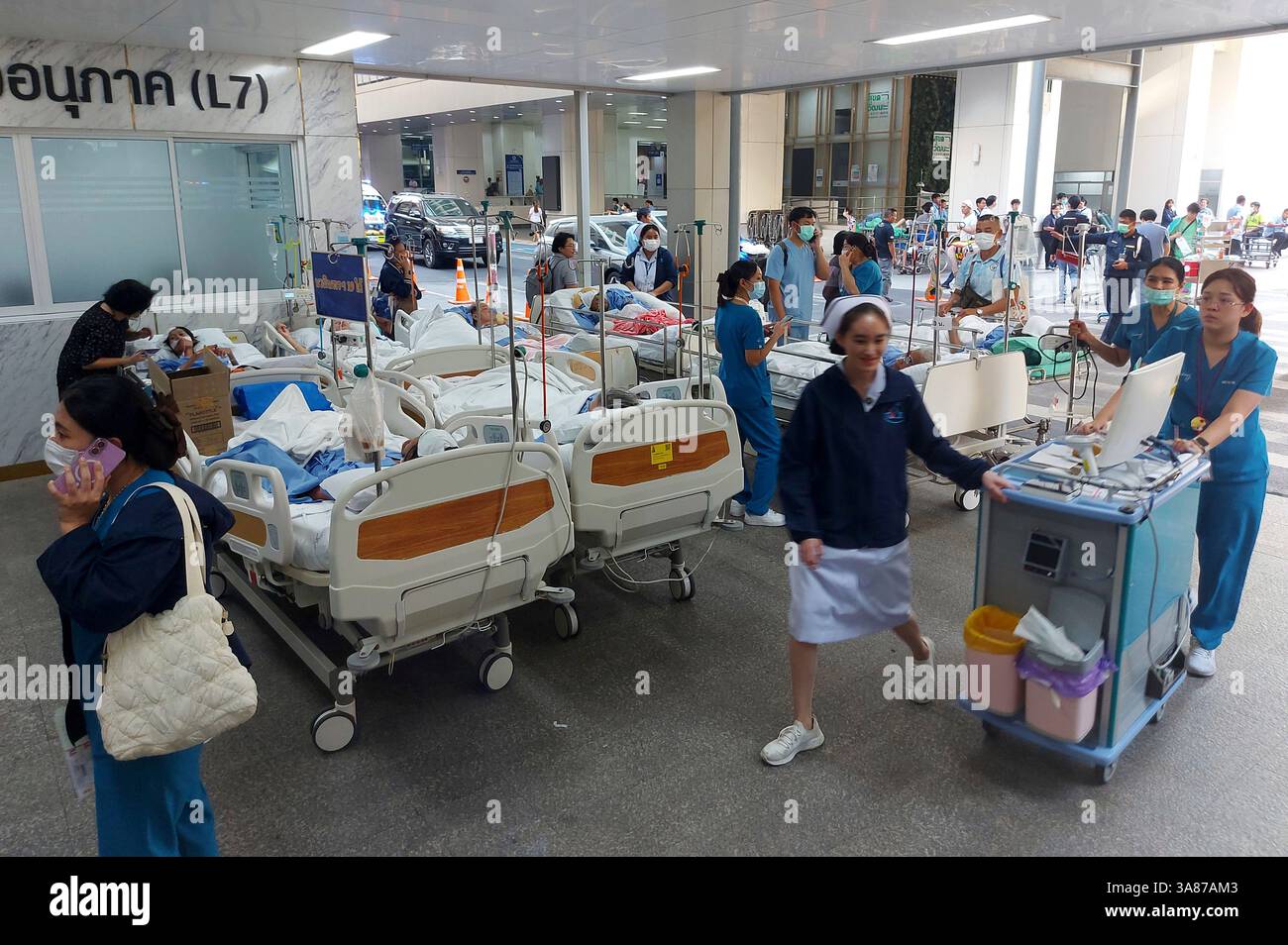 Patients are evacuated outdoors at a hospital after a 7.7 magnitude earthquake in Bangkok ...