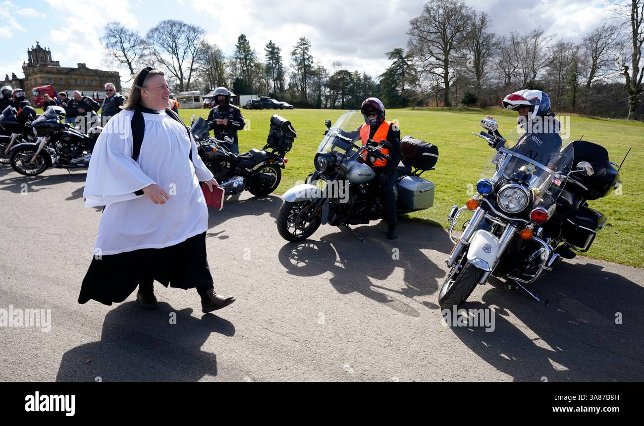 Vicar of Stanton Harcourt, The Revd Jo Hurst, walks past motorcyclists ...