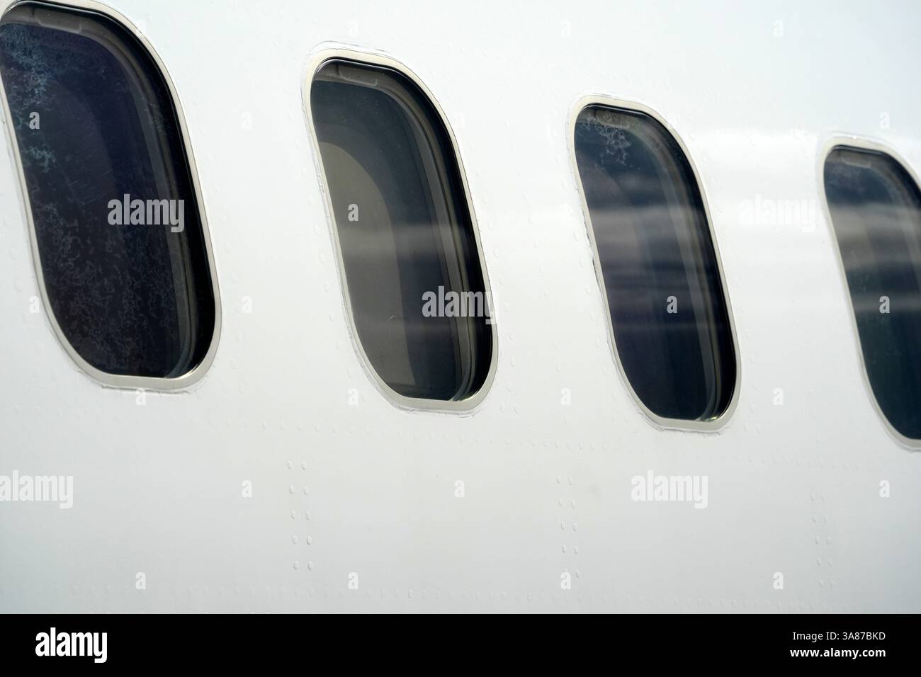 jet airplane detail of cabin windows and fuselage Stock Photo - Alamy