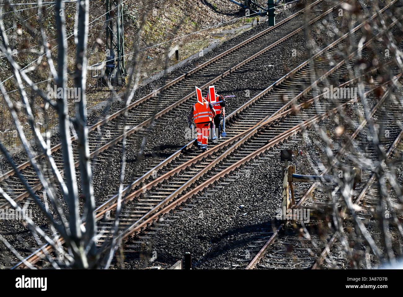 Berlin, Germany. 28th Mar, 2025. Railroad employees walk under the ...