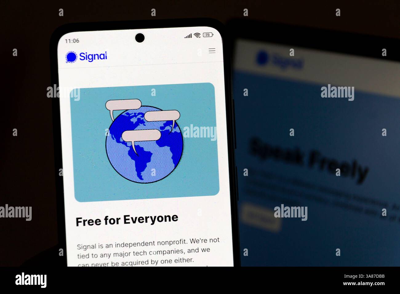 American open-source, encrypted messaging service Signal app on mobile app in front of desktop ...