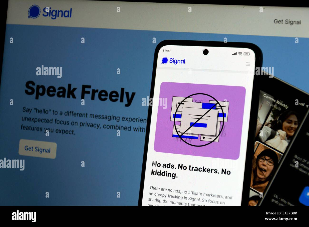 American open-source, encrypted messaging service Signal app on mobile app in front of desktop ...