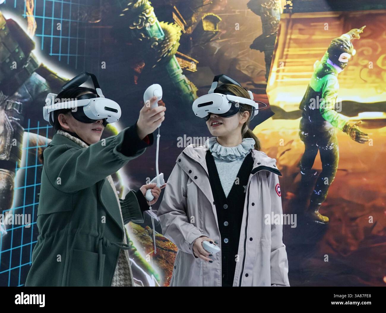 Beijing, China. 28th Mar, 2025. Visitors experience an immersive exhibition during the China ...