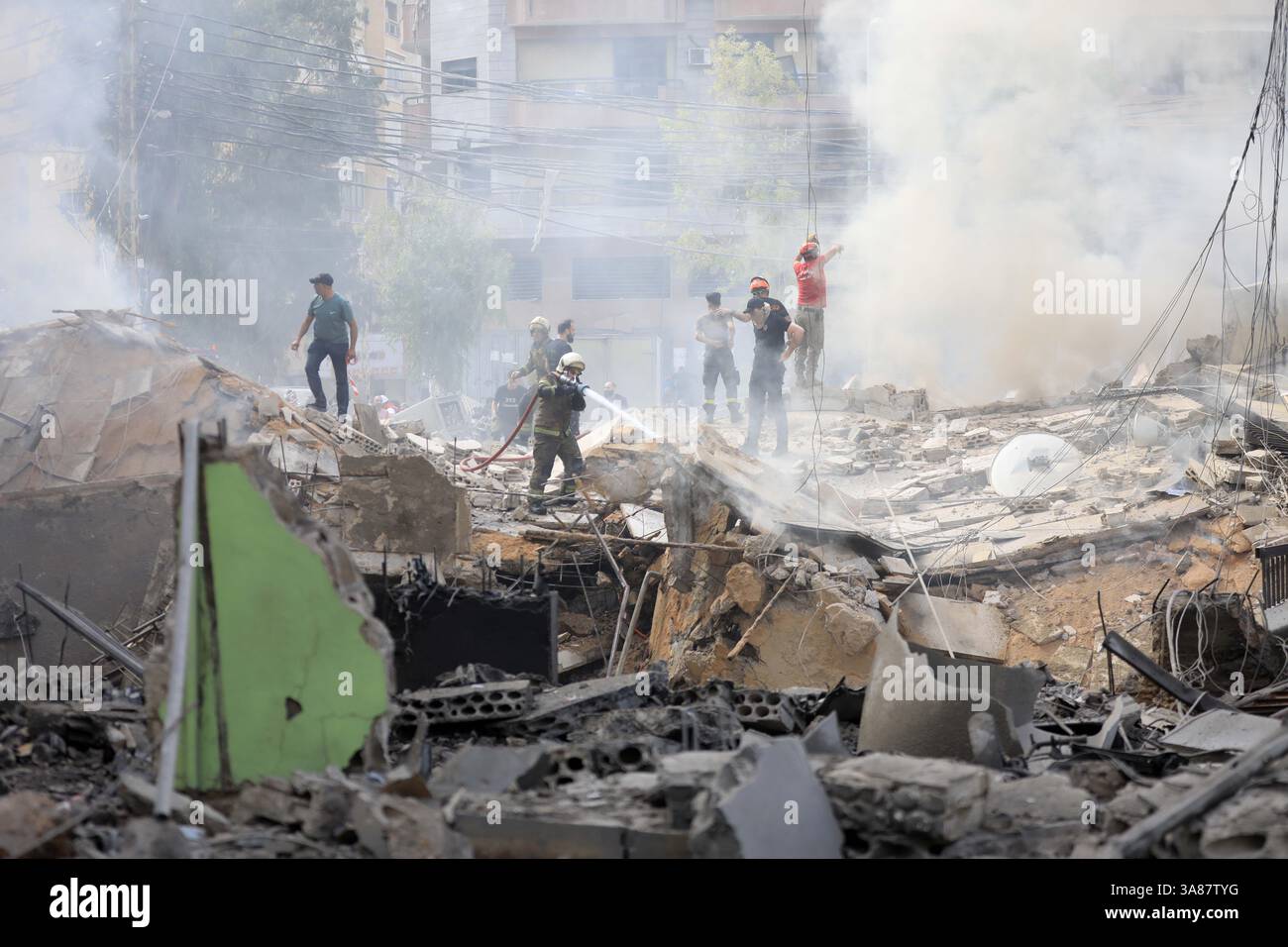 Beirut, Lebanon. 28th Mar, 2025. Firefighters work at the site where a ...