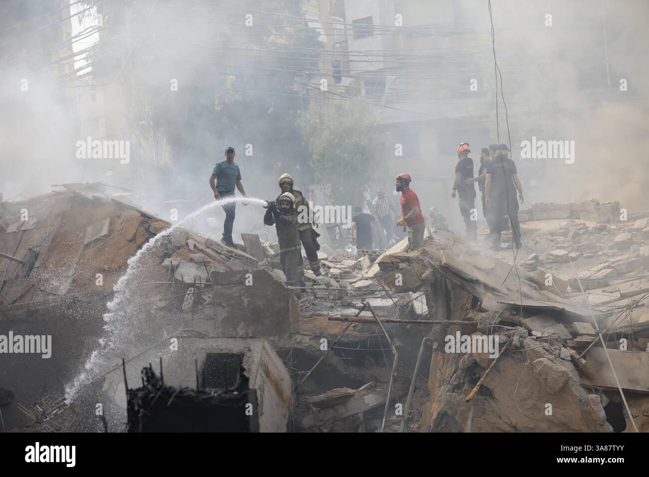 Beirut, Lebanon. 28th Mar, 2025. Firefighters work at the site where a ...