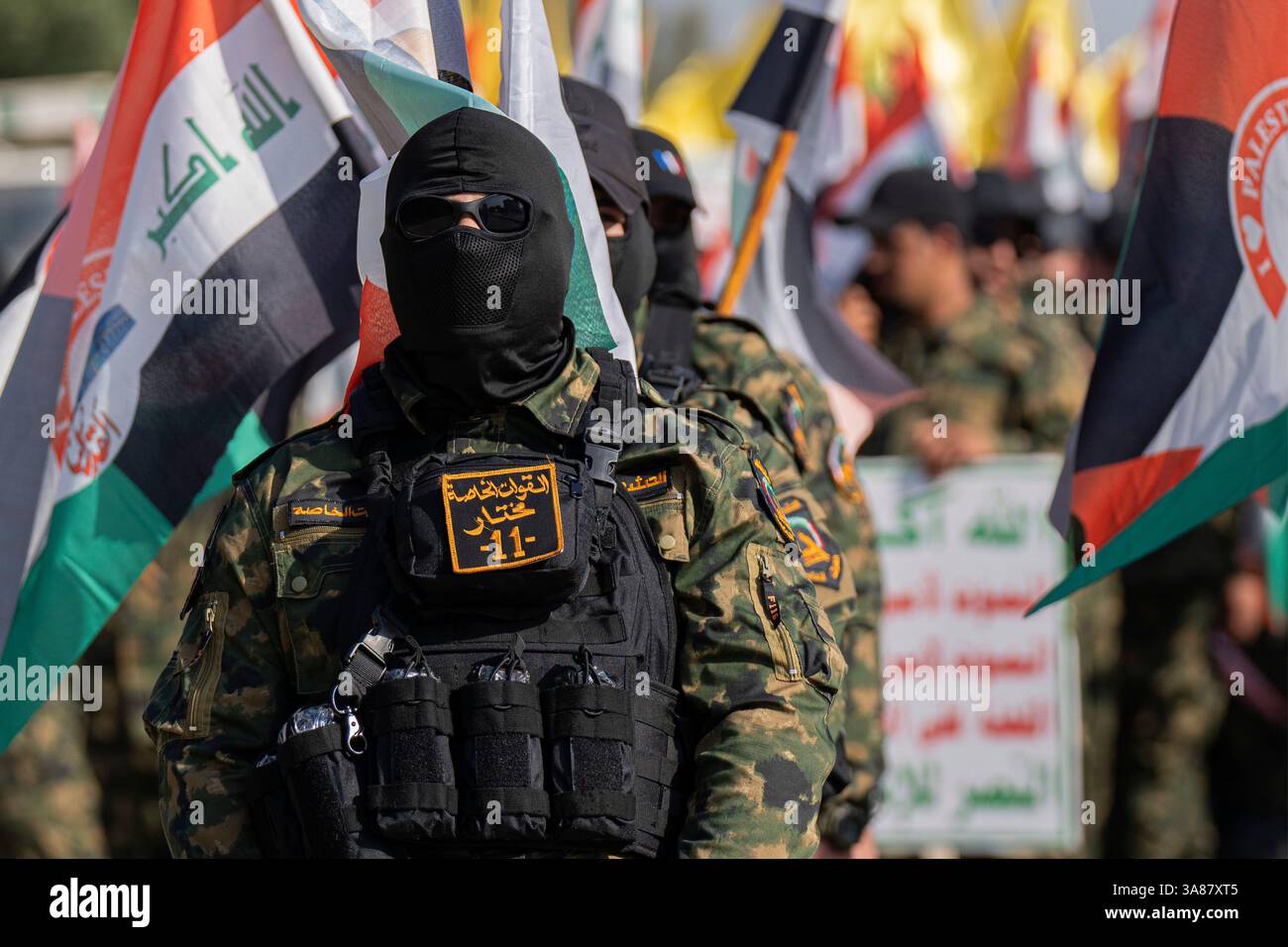 Supporters of Iraqi Hezbollah brigades attend a rally in military ...