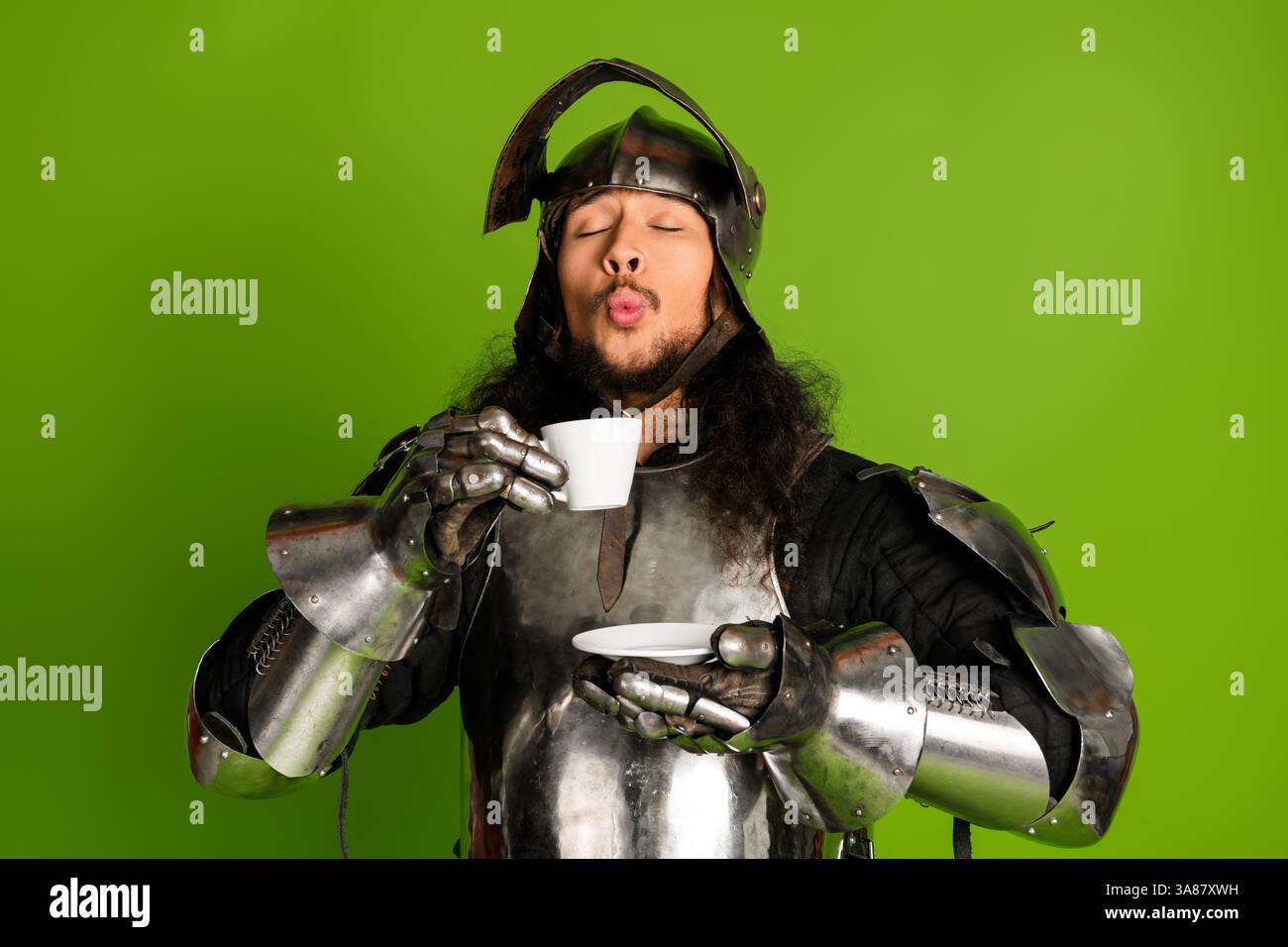 Medieval knight in full armor enjoying a drink on a vibrant green ...