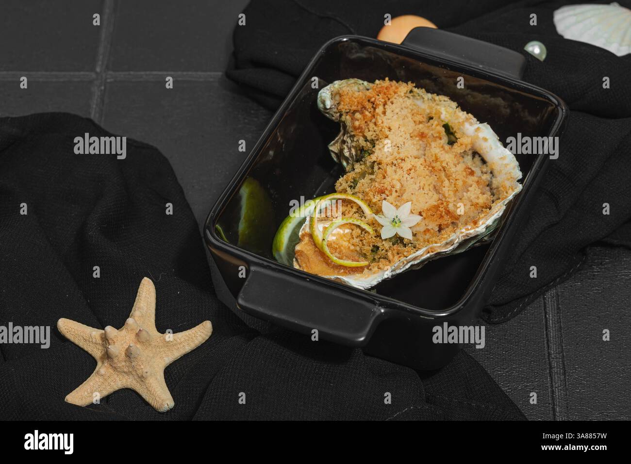 Gourmet baked oyster with herbs and cheese. Elegant seafood dish ...