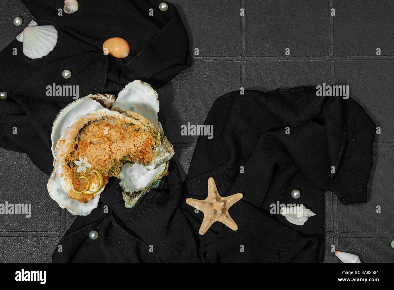 Gourmet baked oyster with herbs and cheese. Elegant seafood dish ...