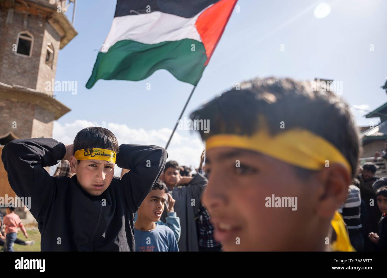 A Muslim man waves a Palestinian flag during a rally marking Quds Day ...