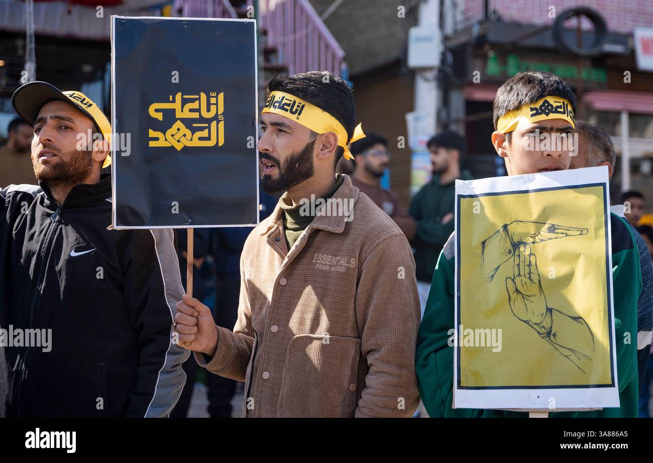 Muslim men walk with placards during a rally marking Quds Day ...