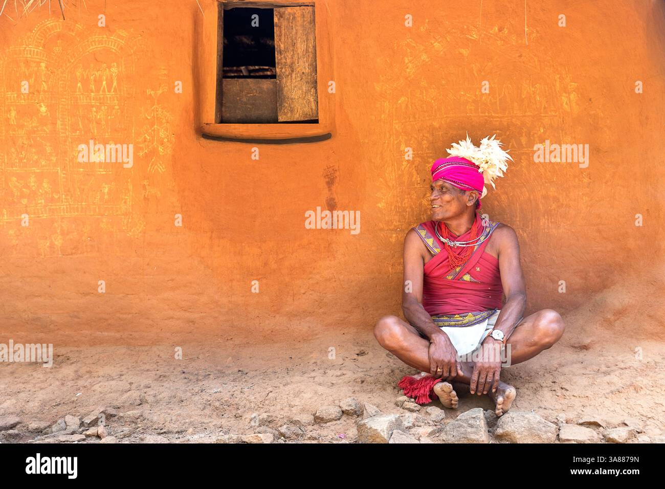 Man from a remote Lanjia Saura tribe in traditional colourful costume ...