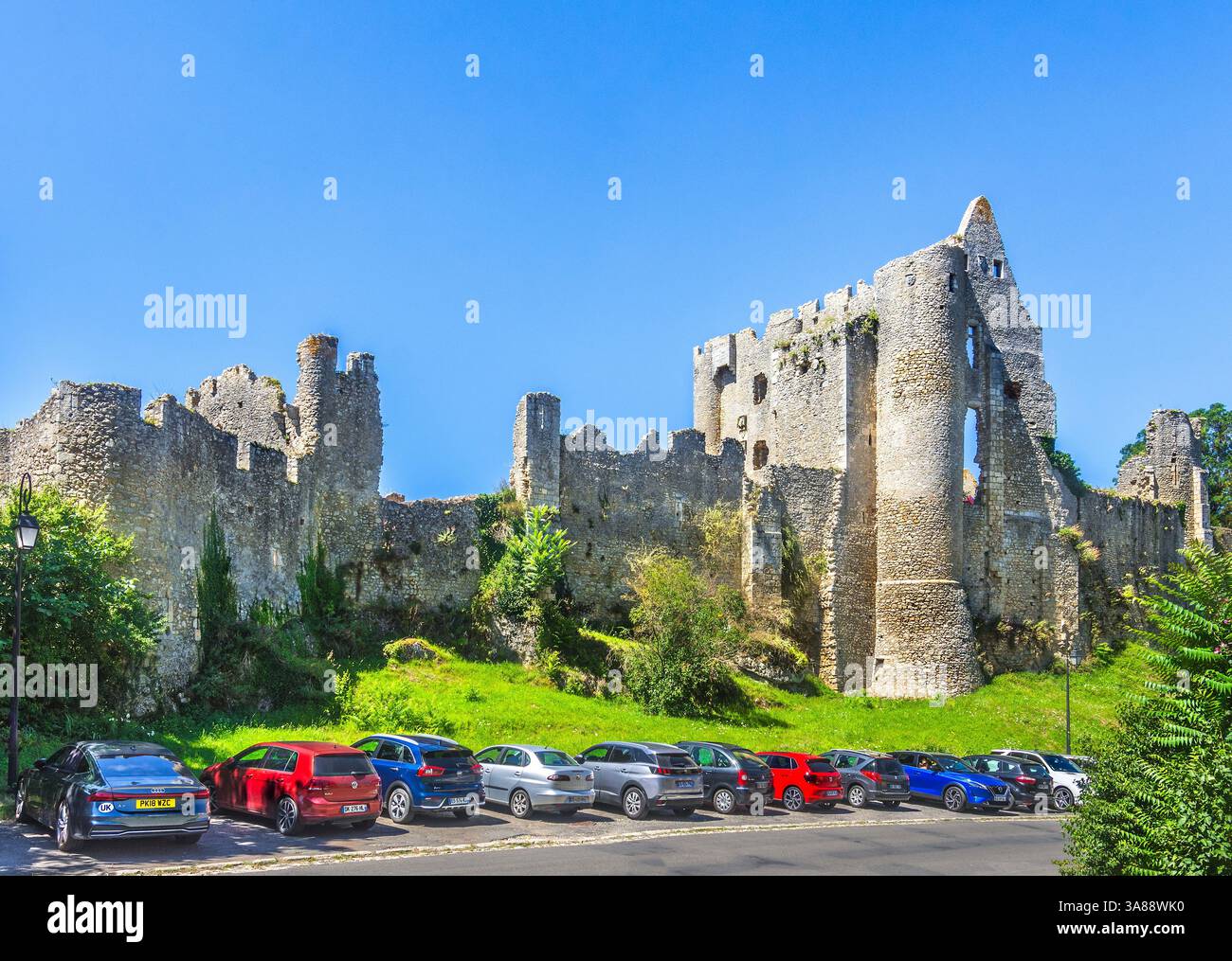 Cars parked in parking space under the medieval castle walls of Angles ...