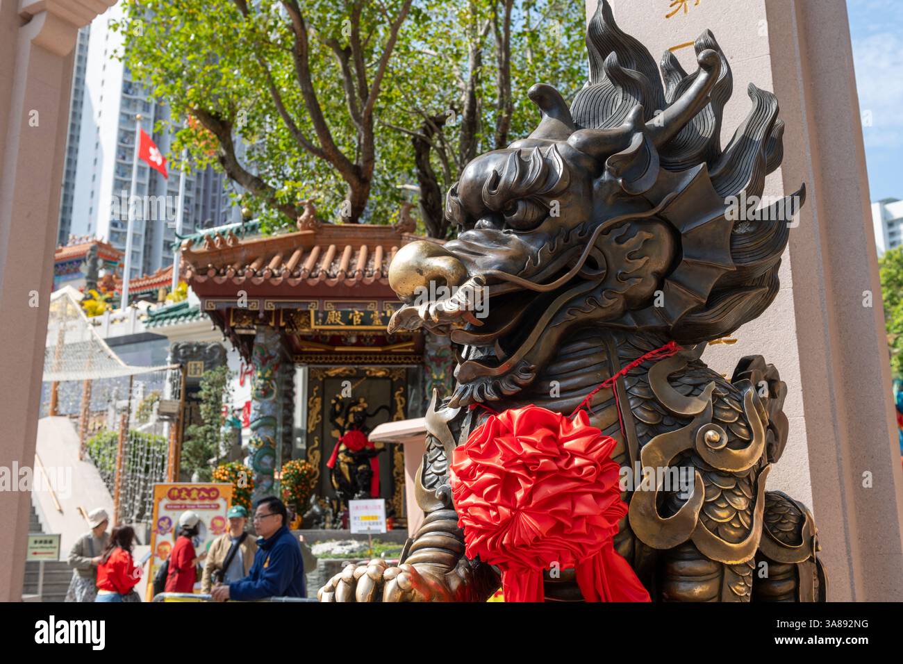 Hong Kong. China- 02.24.2025. A bronze dragon statue by the entrance ...