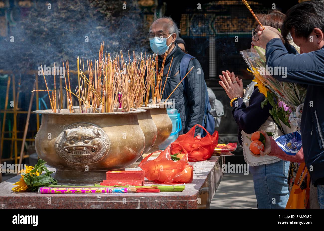 Hong Kong. China- 02.24.2025. Pilgrims offering religious goods ...