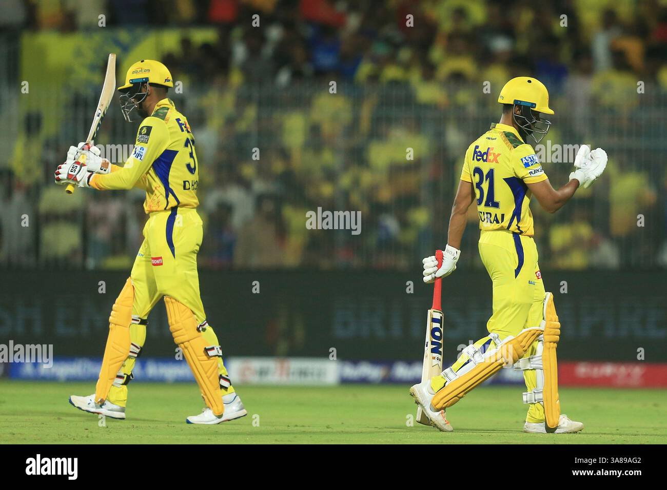 Chennai Super Kings' captain Ruturaj Gaikwad, right, walks off the ...