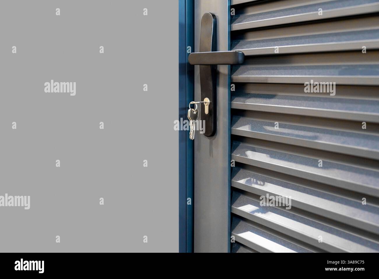 Keys in lock of metal door Stock Photo - Alamy
