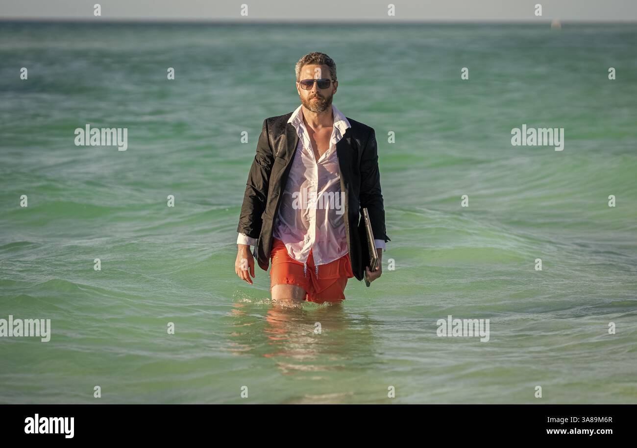 Hot business summer. business boss spending weekend at the beach ...