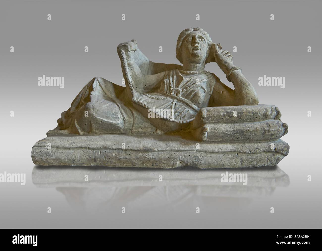 Reclining women on the lid of an Etruscan funerary cinerary urn ...