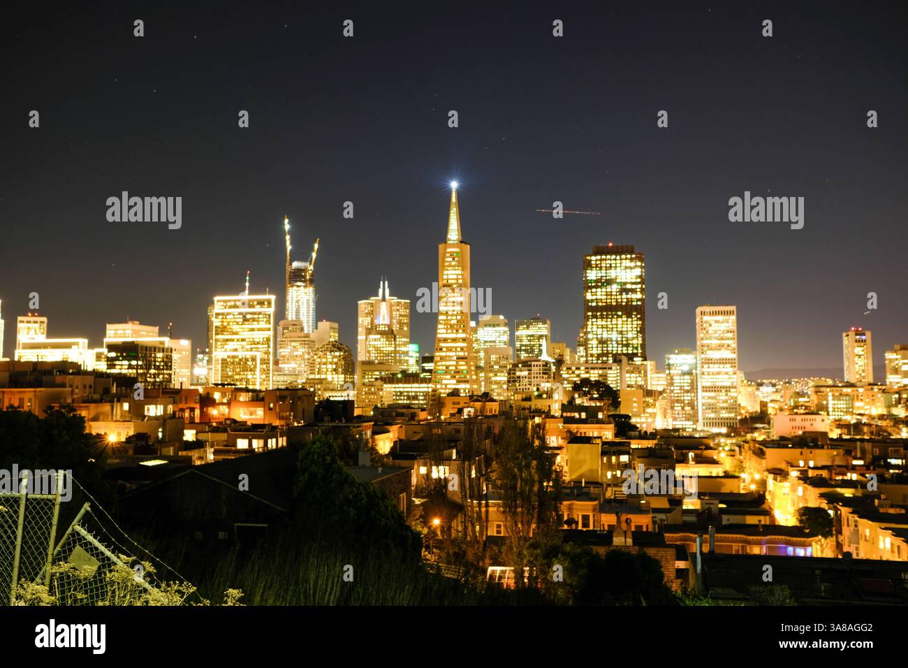 San Francisco's skyline glows at night, featuring the iconic ...