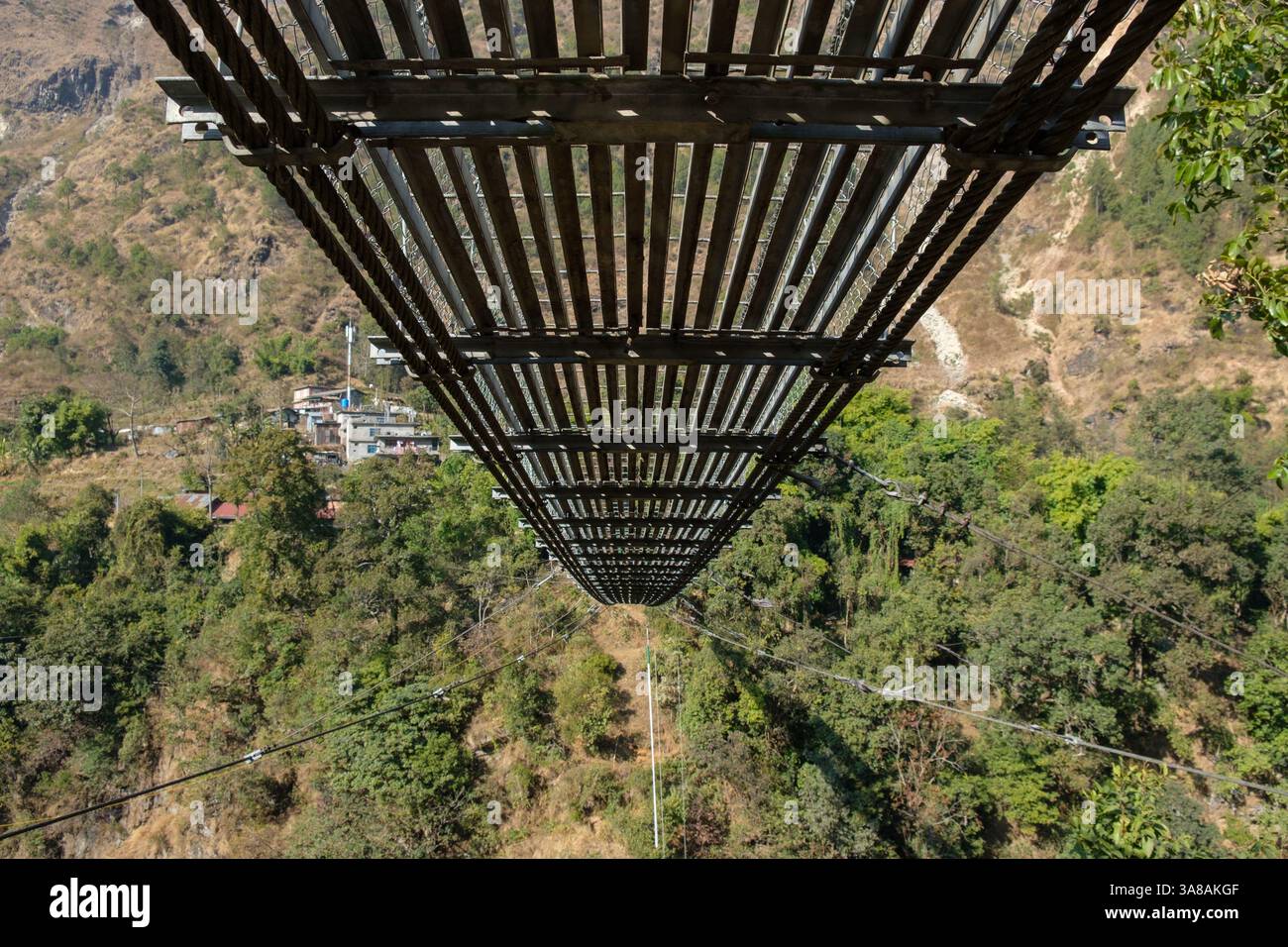 Crossing a deep gorge on a suspension bridge, offering a dizzying view ...