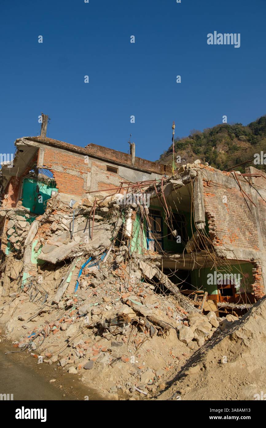 A building lies in ruins, reduced to rubble and debris, likely ...