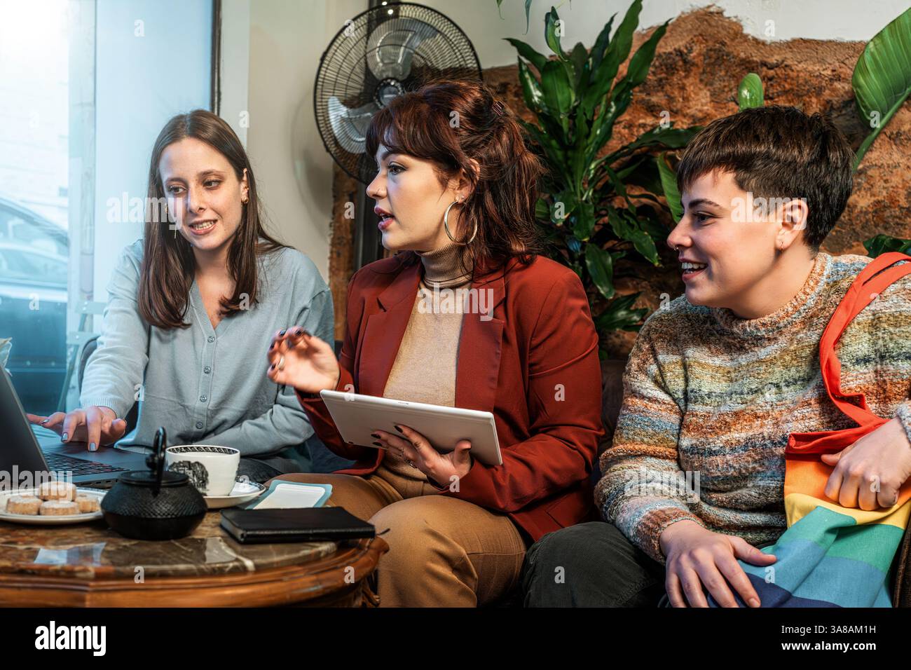 Three diverse young professionals gathering hi-res stock photography ...