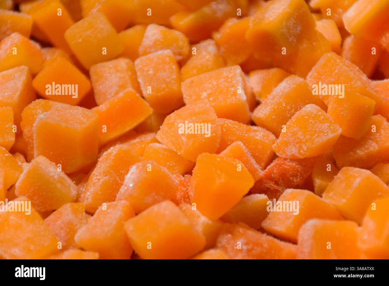 Roughly cut in cubes frozen butternut squash background with selective ...