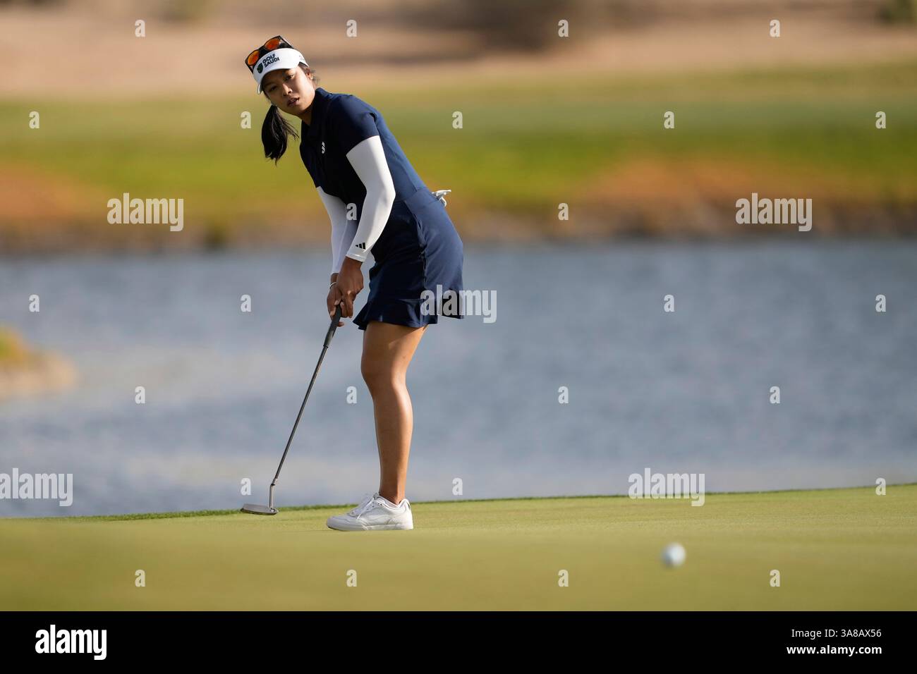 Patty Tavatanakit, of Thailand, watches her shot on the 12th green ...