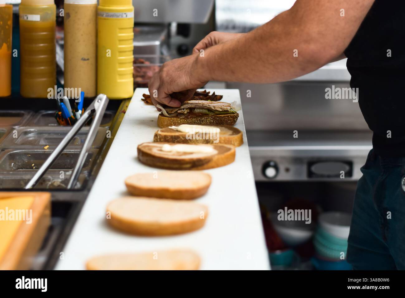 Restaurant employee making sandwiches for take out order Stock Photo ...