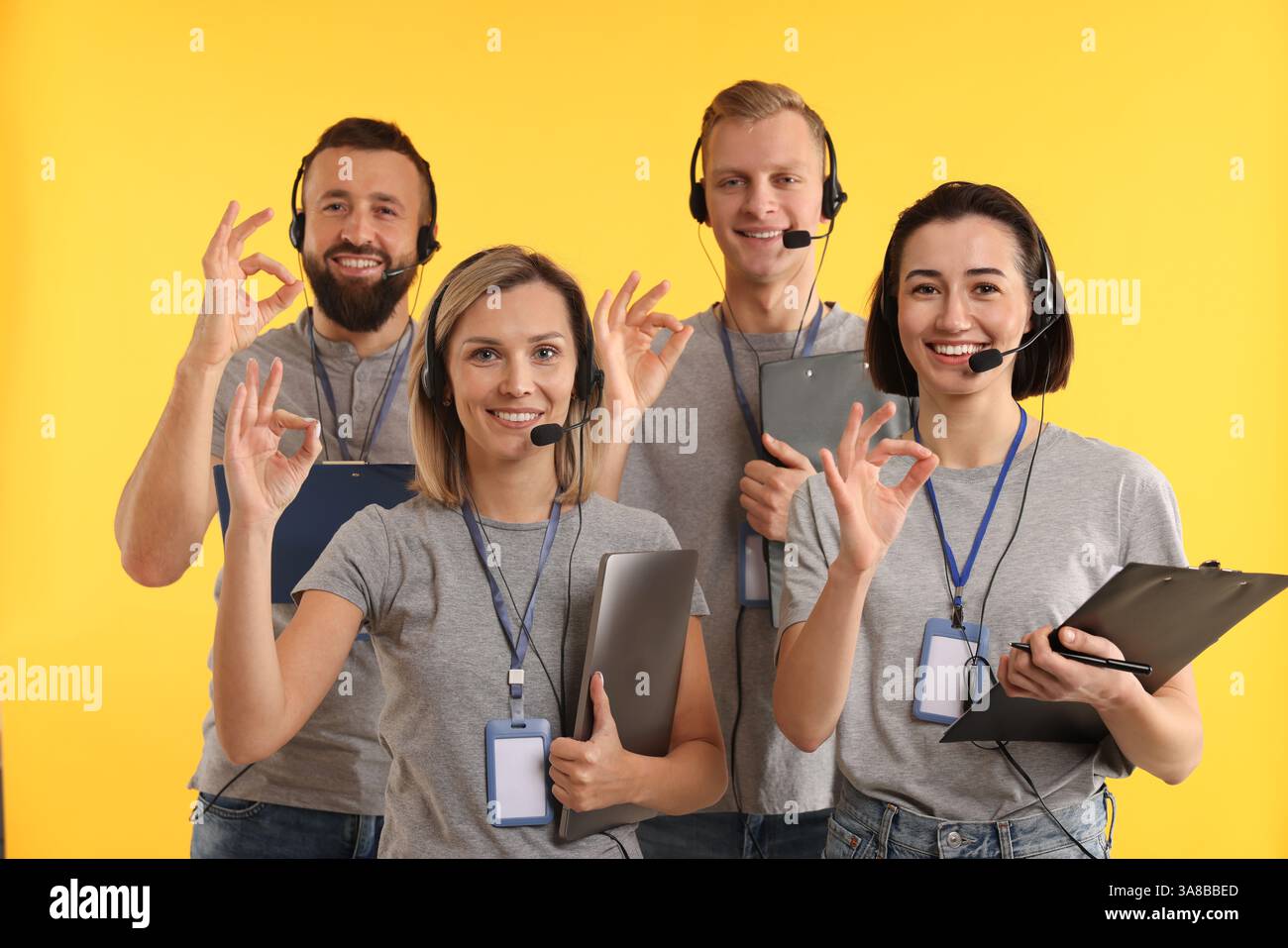 Technical support call center. Team of friendly operators showing ok ...