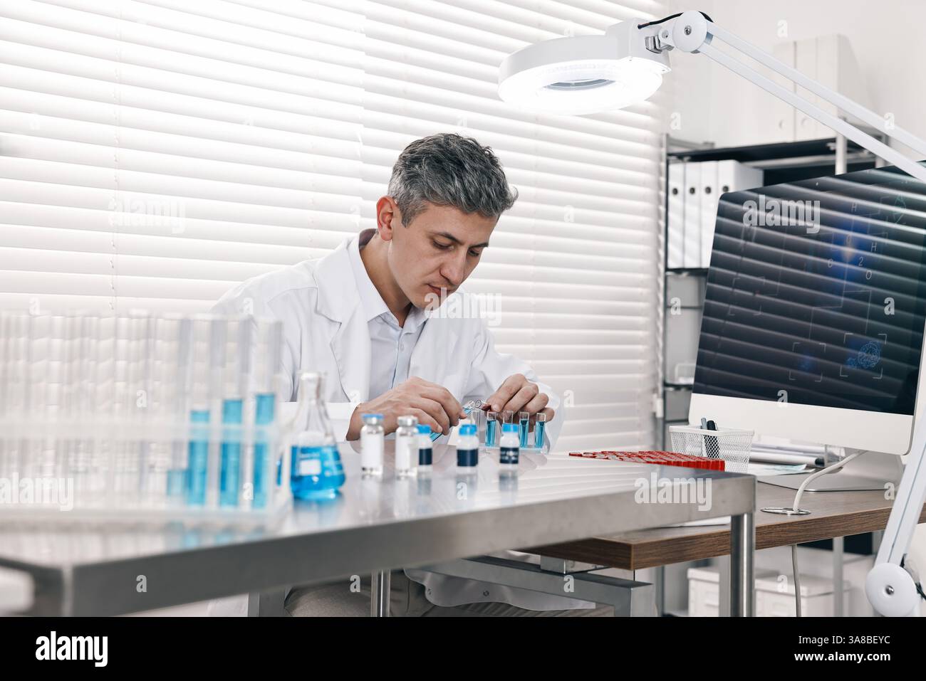Scientist with test tubes working in laboratory Stock Photo - Alamy