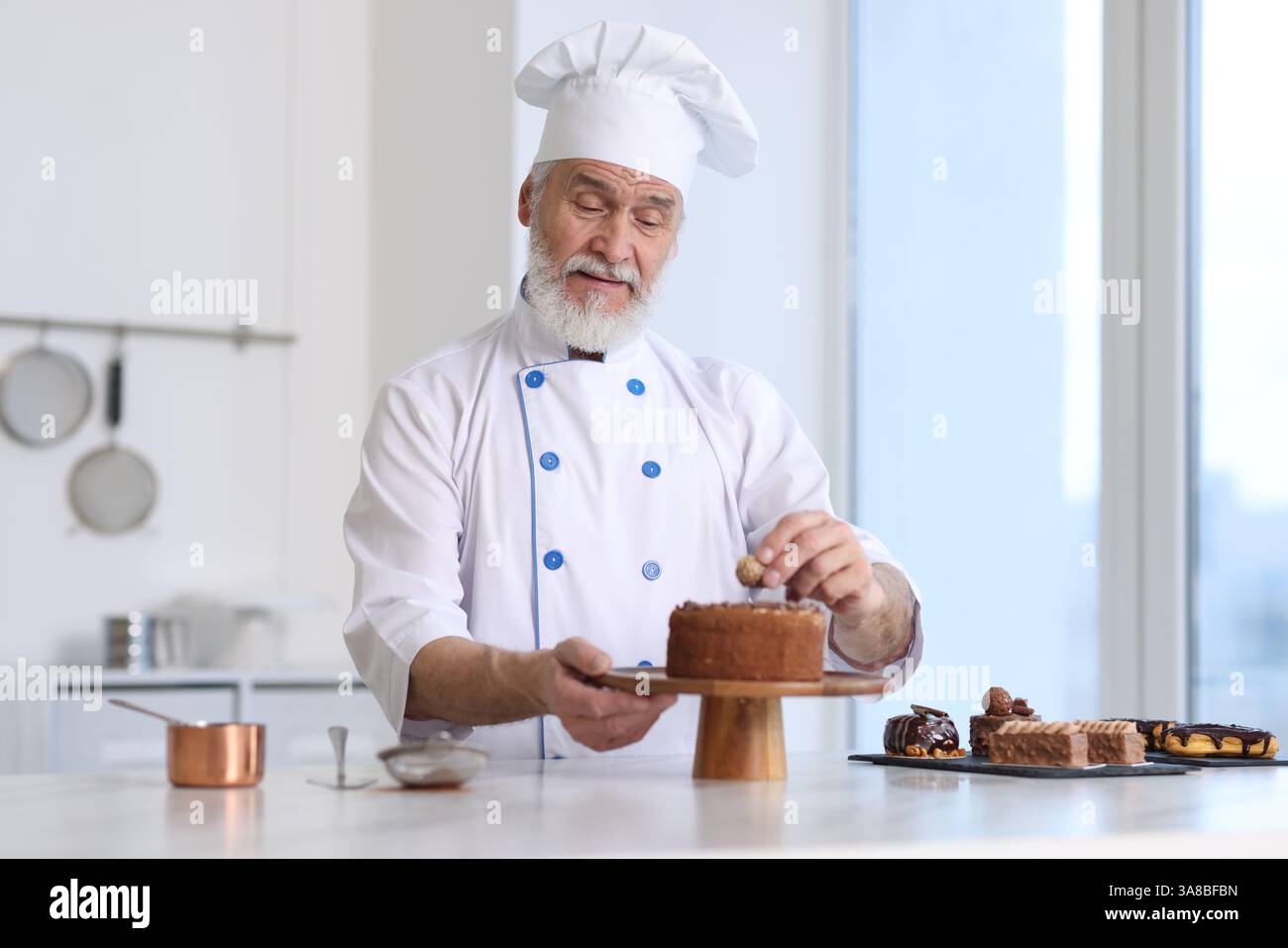 Elderly pastry chef decorating hi-res stock photography and images - Alamy