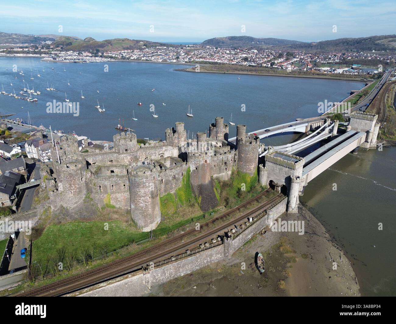 Aerial view of Conwy Castle and railway bridge across the Conwy river ...