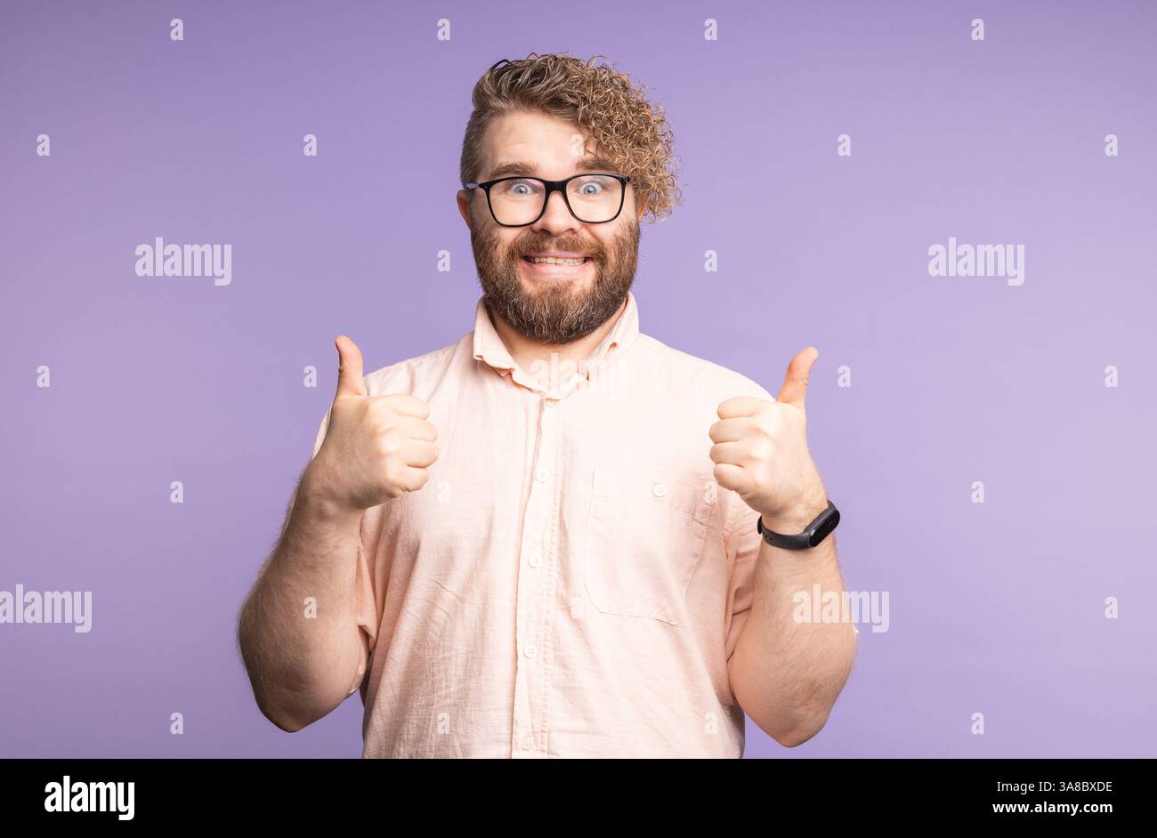 Crazy funny man showing double thumbs up on purple background ...