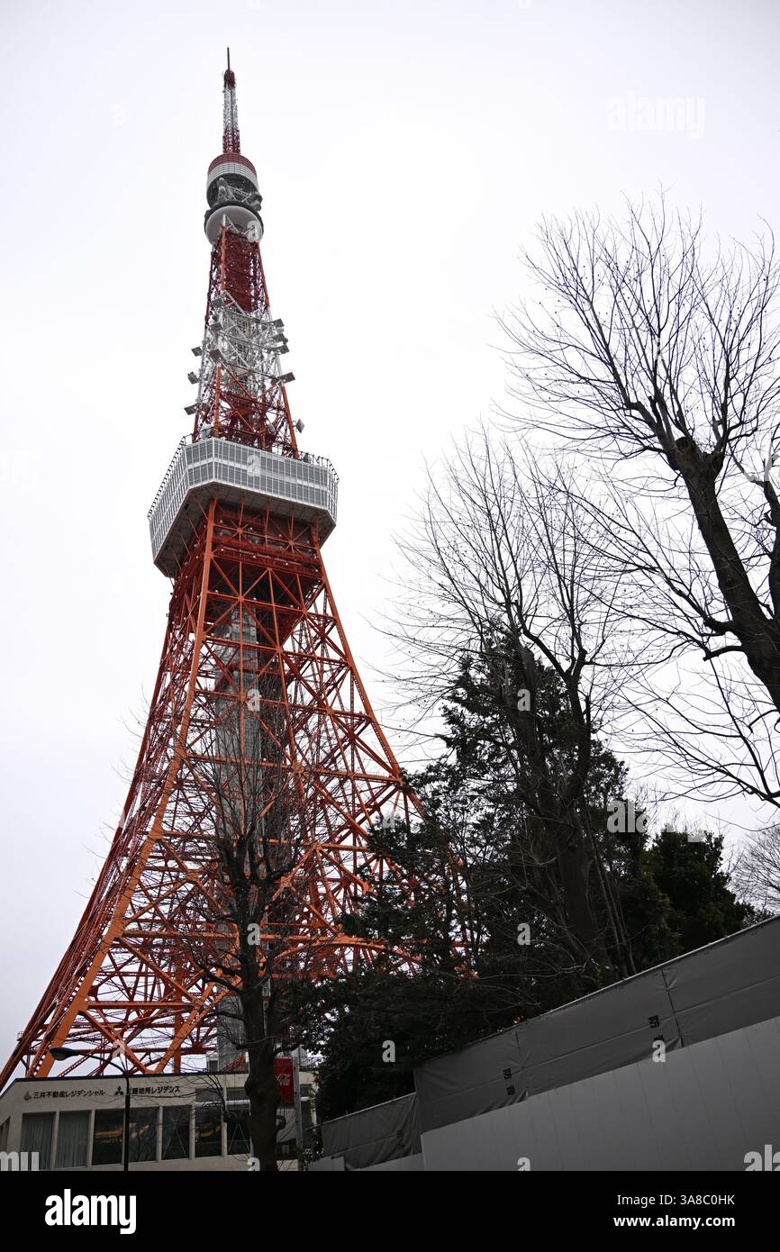 Tokyo Tower viewed from below on an overcast day in Tokyo, Japan – low-angle architectural ...