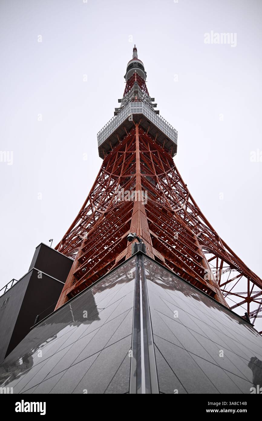 Tokyo Tower viewed from below on an overcast day in Tokyo, Japan – low-angle architectural ...