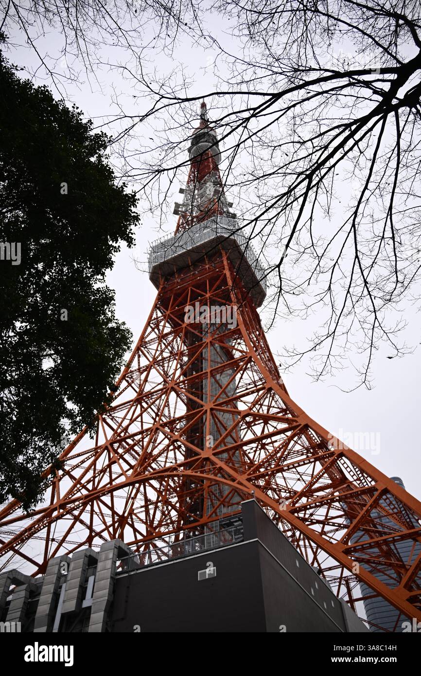 Tokyo Tower viewed from below on an overcast day in Tokyo, Japan – low-angle architectural ...