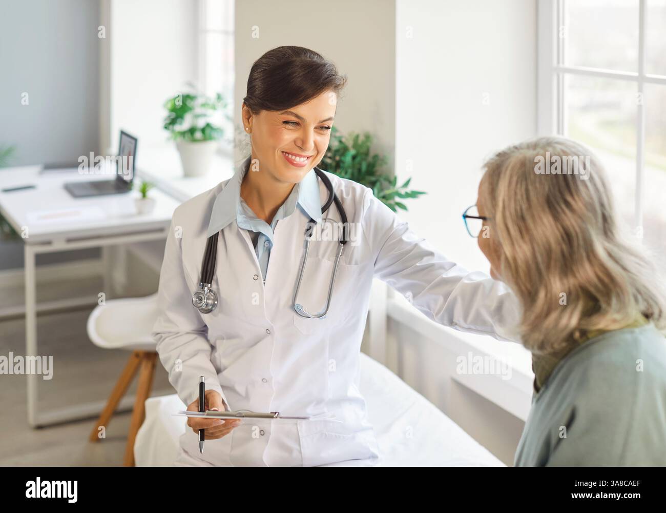 Doctor has warm conversation with her patient and cheers her up by ...