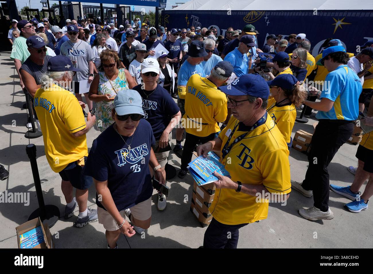 Tampa Bay Rays fans pick up schedule magnets ars they enter ...