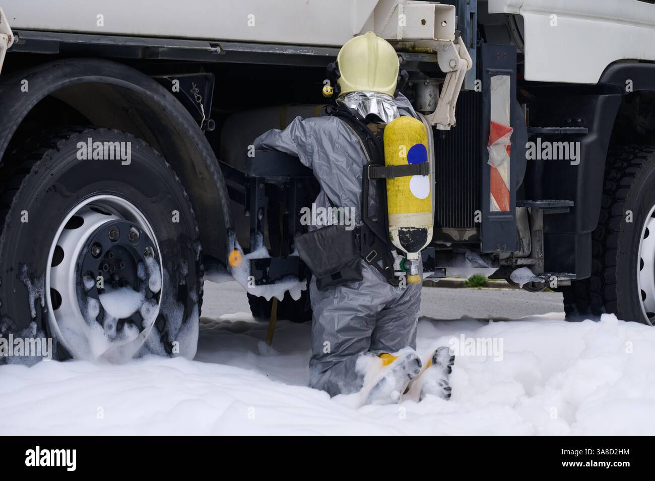 Emergency personnel dressed in hazmat suits and self-contained ...