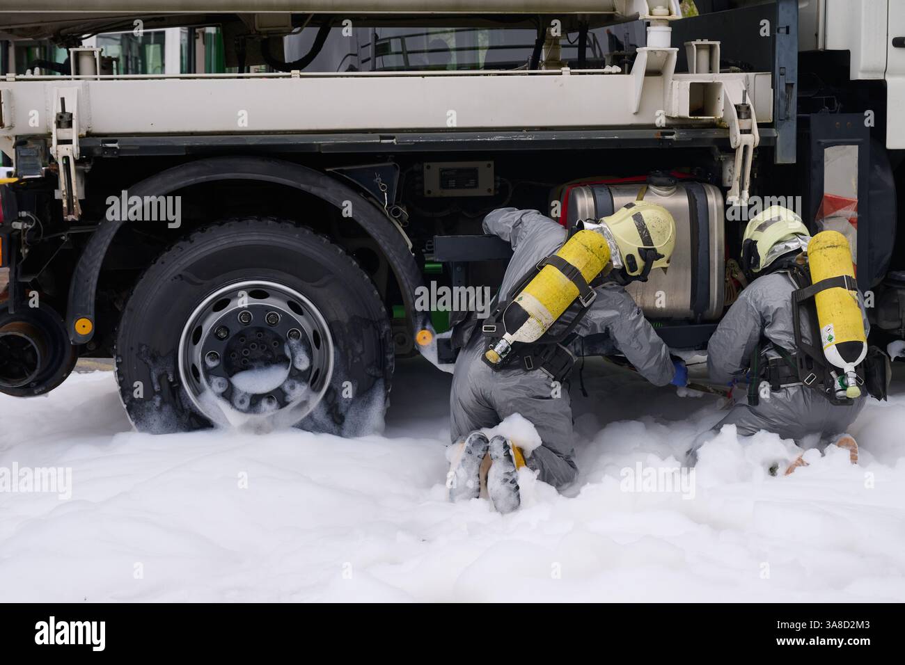 Emergency personnel dressed in hazmat suits and self-contained ...