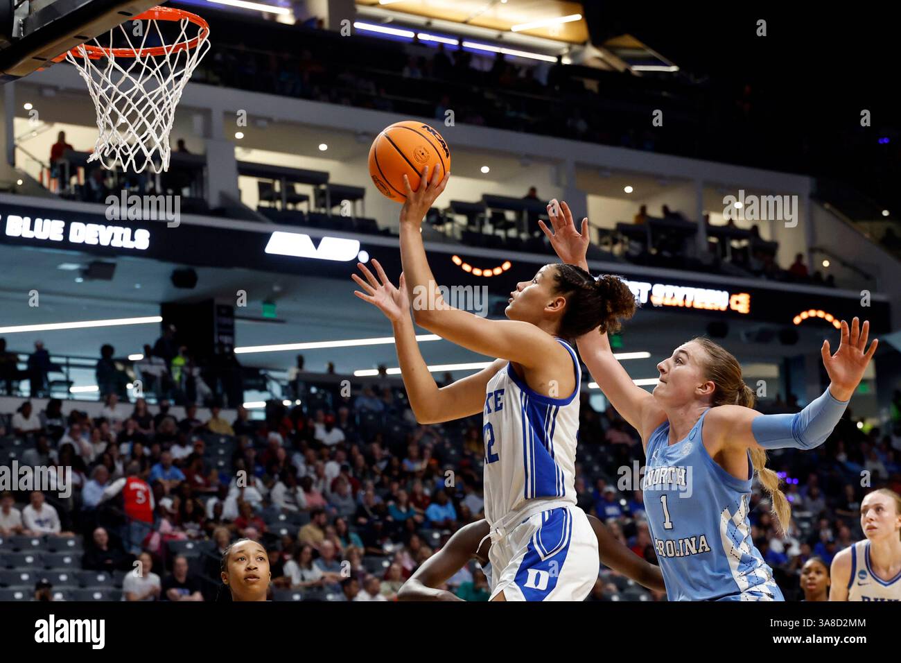 Duke forward Delaney Thomas (12) goes by North Carolina guard Alyssa ...