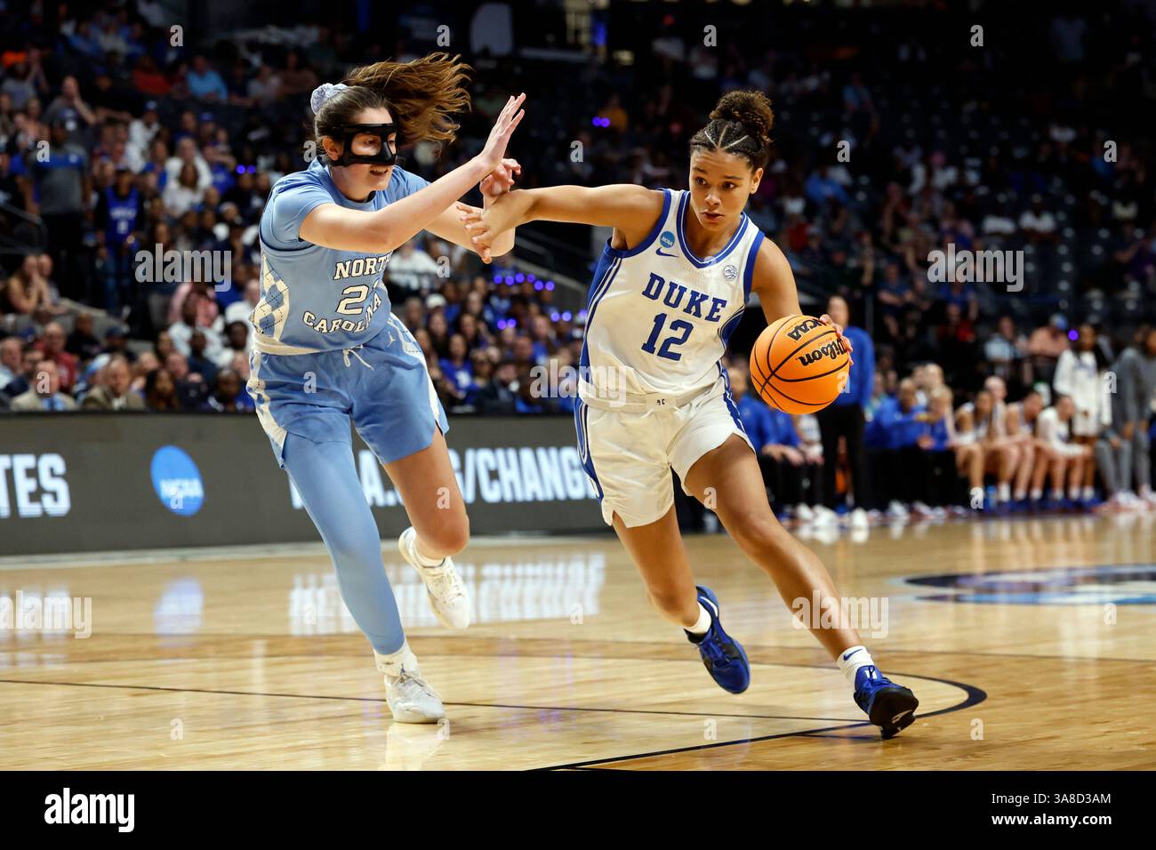 Duke forward Delaney Thomas (12) dribbles around North Carolina forward ...
