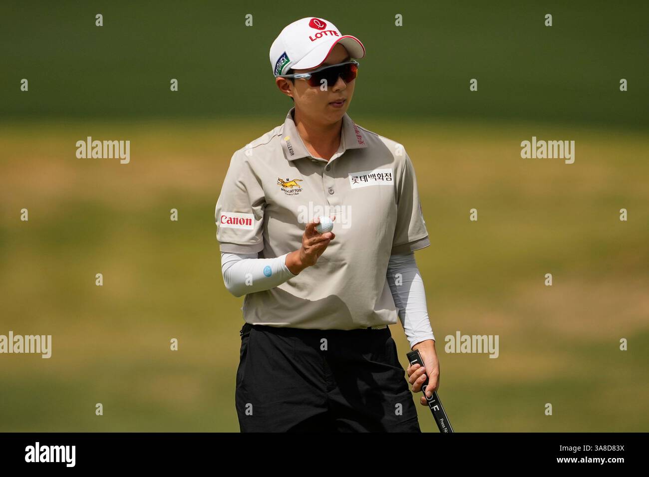 Hyo Joo Kim, of South Korea, waves after her shot on the 18th green ...