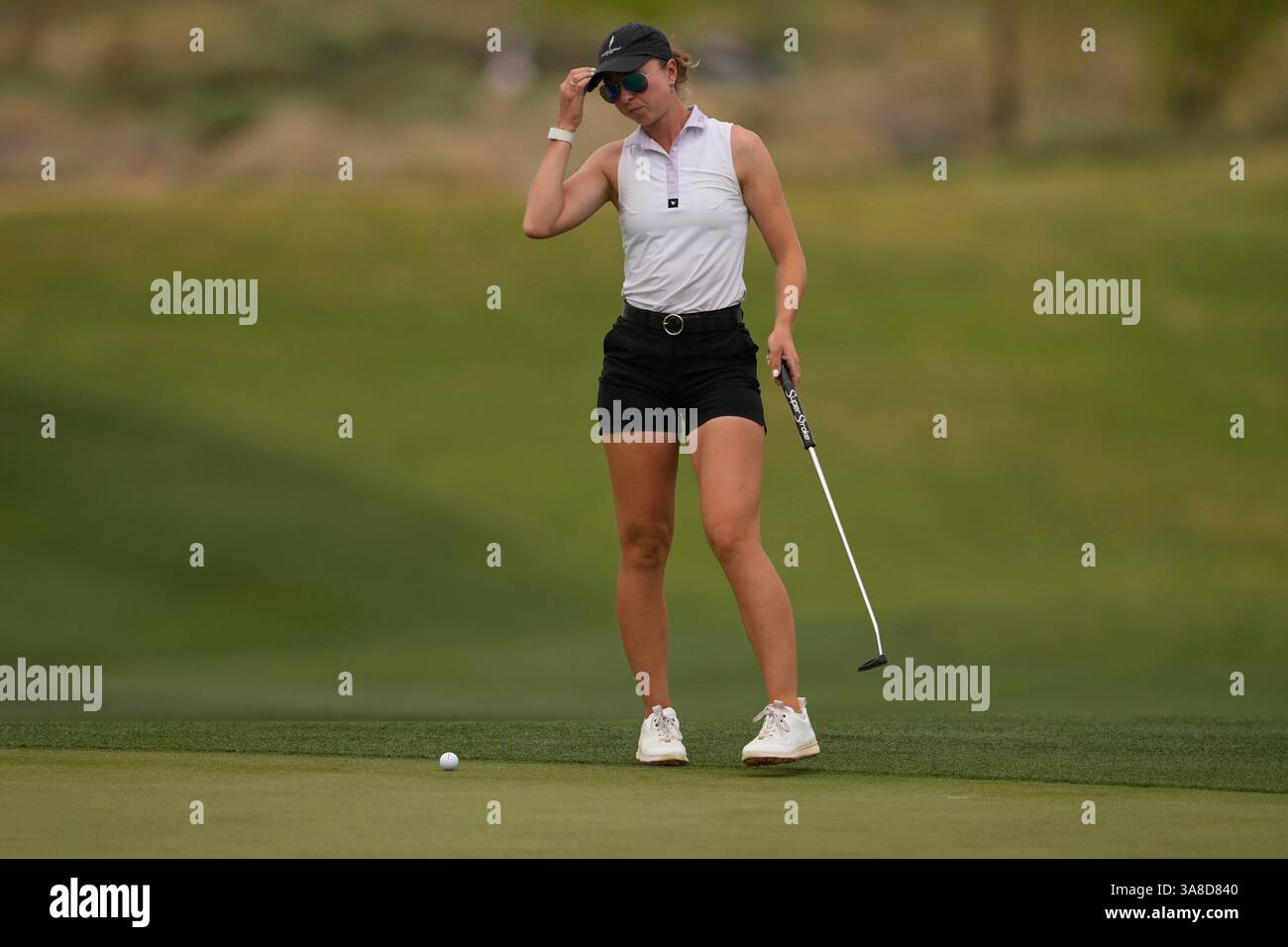 Polly Mack, of Germany, looks at her ball on the 18th green during the ...