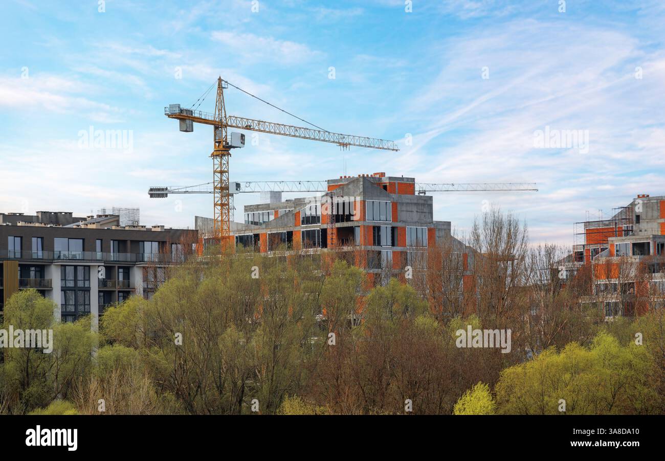 A modern residential complex under construction, featuring concrete and ...