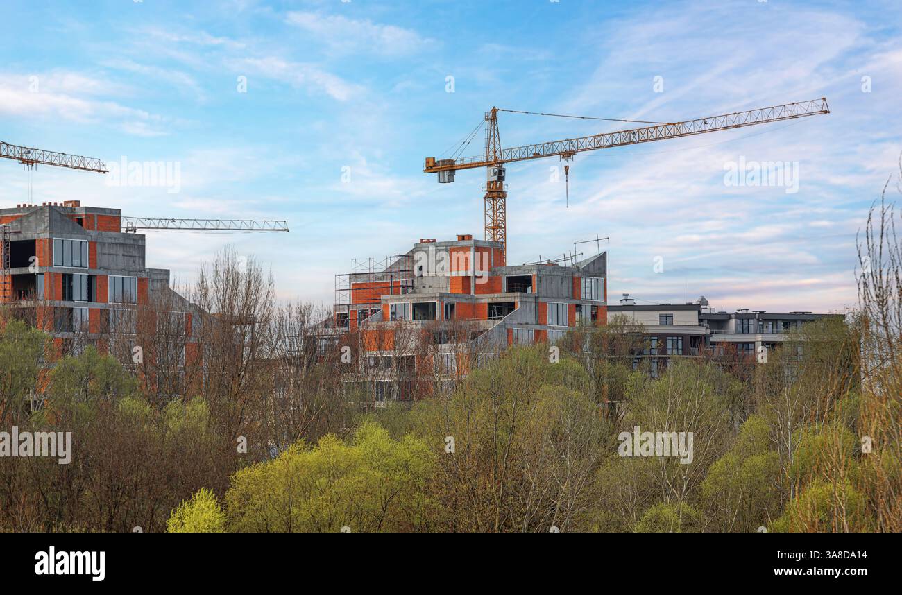 A modern residential complex under construction, featuring concrete and ...