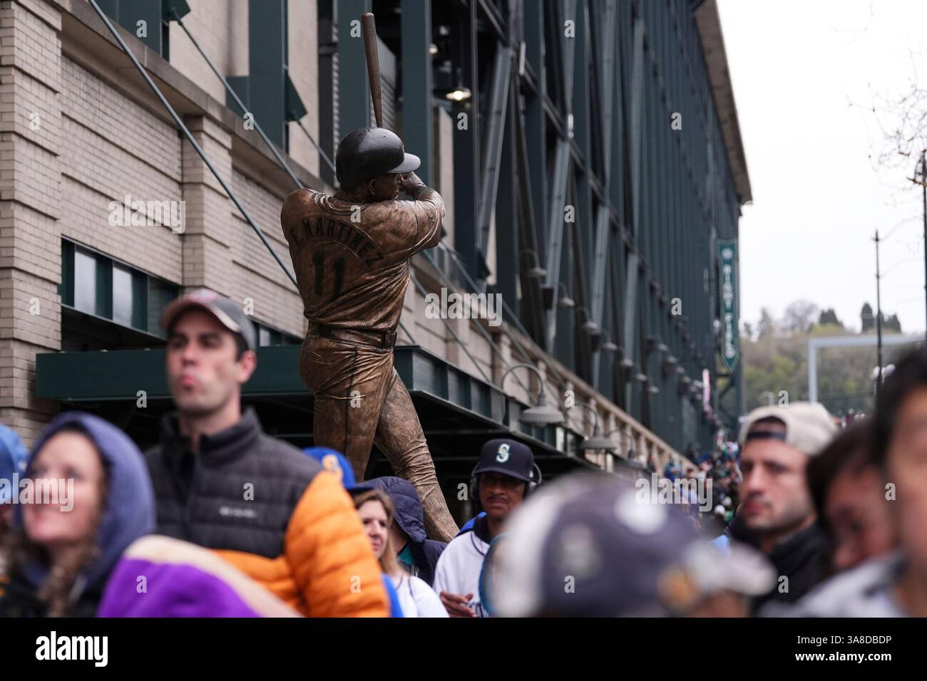 Fans line up outside T-Mobile Park and a statue of Seattle Mariners ...